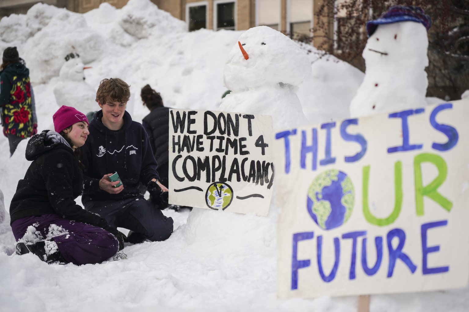Photos: Students, community members create snowmen against climate ...